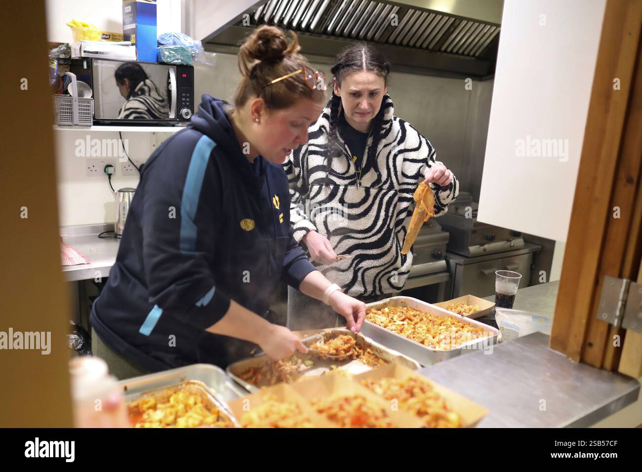 Teddington's Chloe Spriggs, right, a year 4 teacher, reacts as food is ...