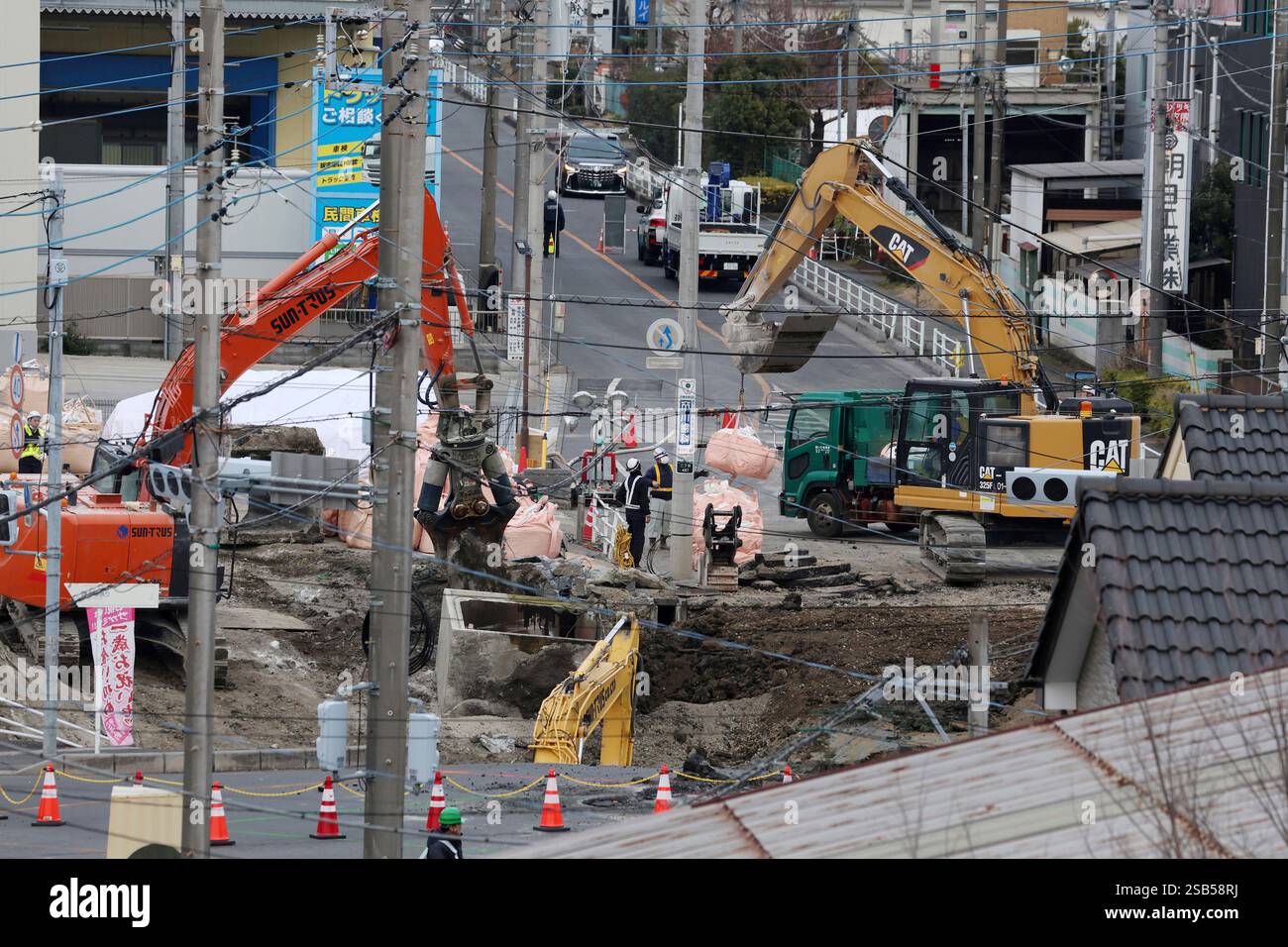 A photo shows the site of a road collapsed above huge sinkholes at an ...