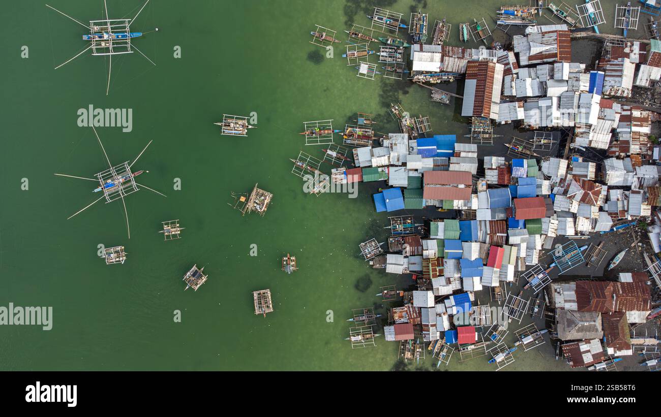Fishing boats and stilt houses over the water in Bohol, Philippines ...