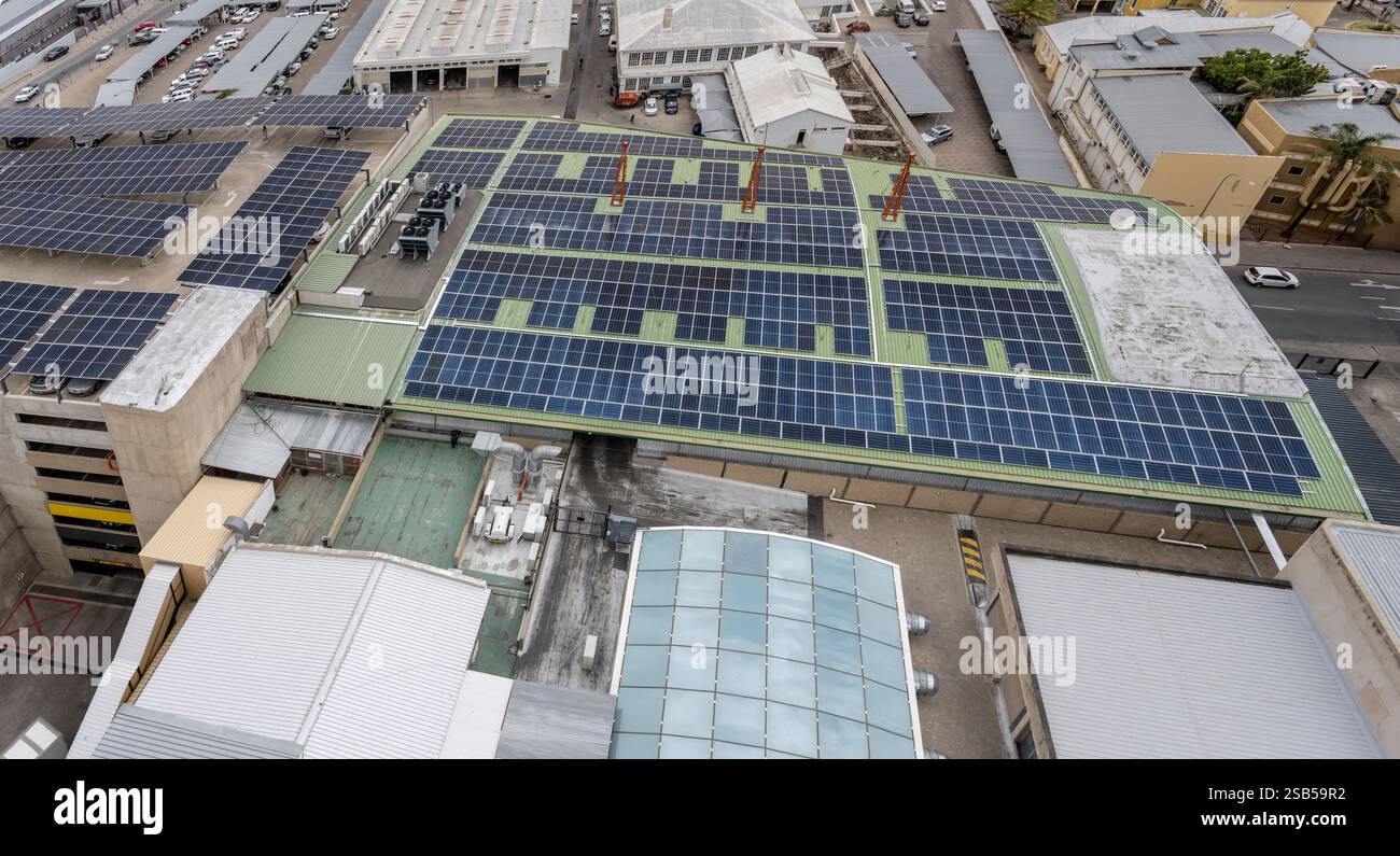 aerial cityscape with a lot of solar panels on roofs in town center ...