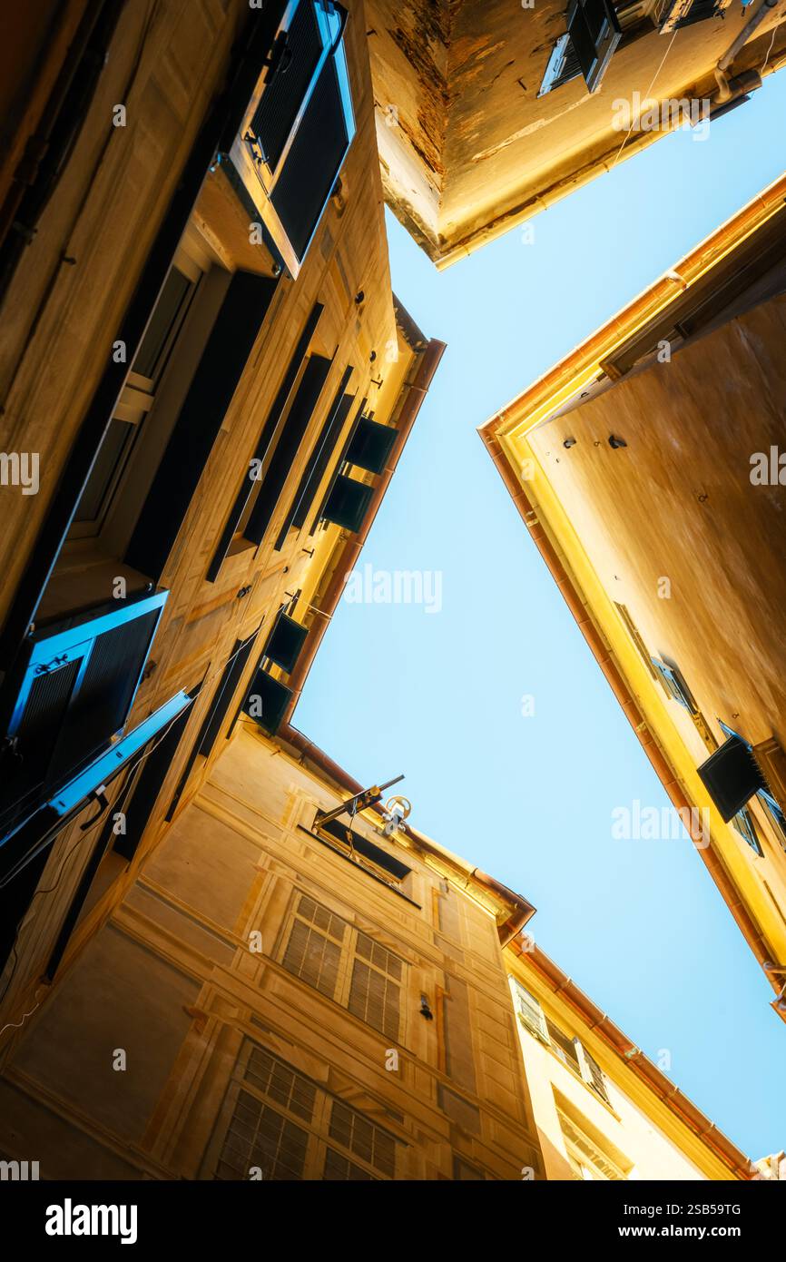 Perspective view from bottom to top on the old buildings and blue sky ...
