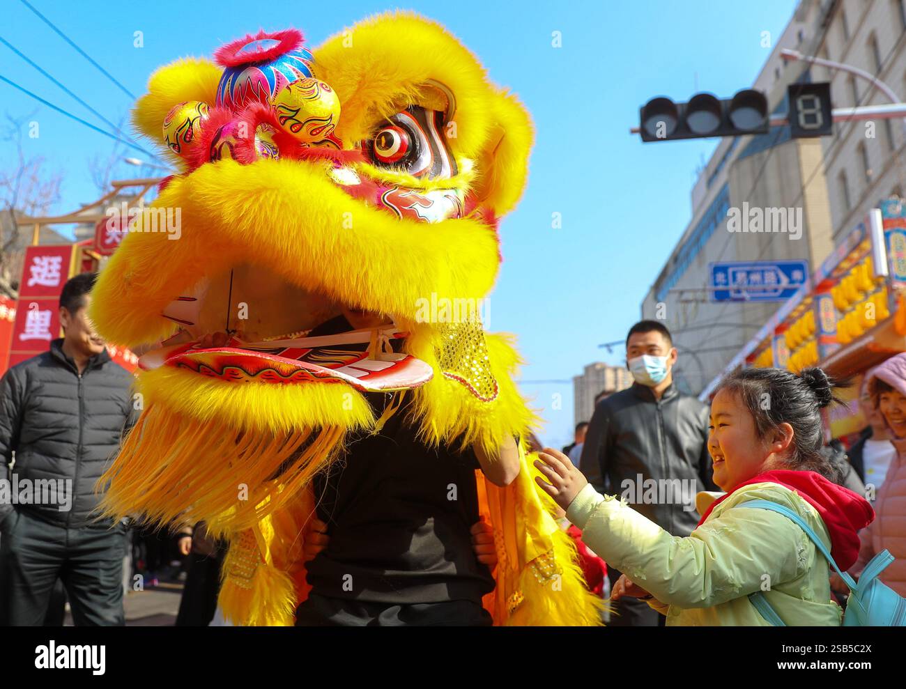 A child interacts with a lion dance performance at Dabao Island ...