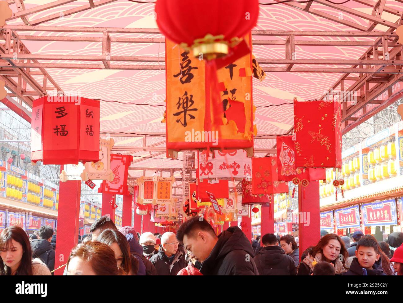 Tourists play in a lantern riddle-riddled corridor at Dabao Island ...
