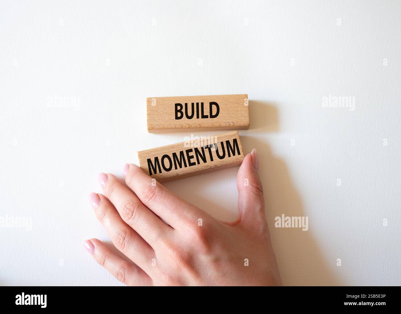 Build momentum symbol. Wooden blocks with words Build momentum ...