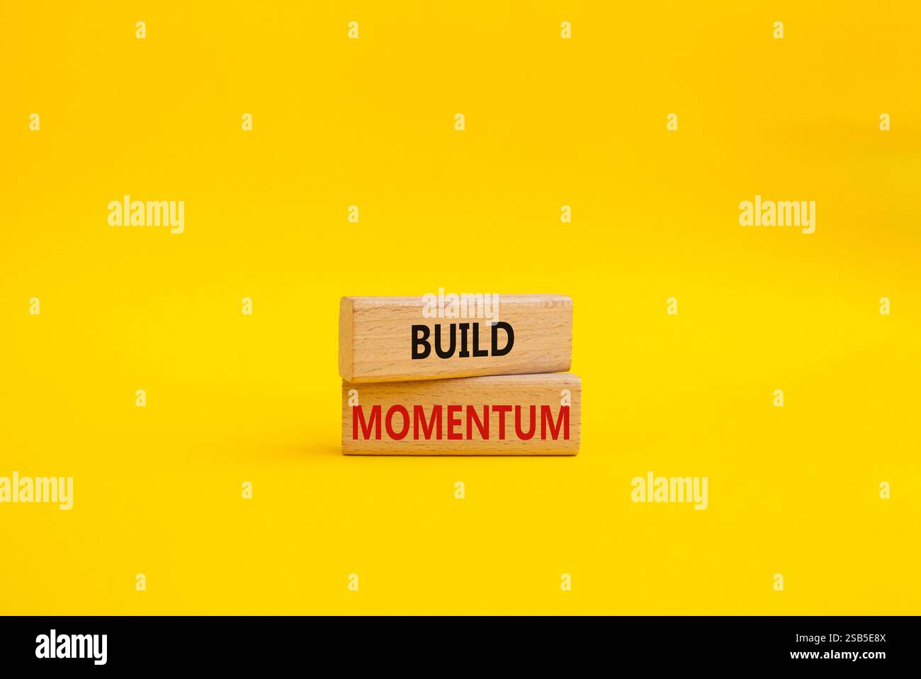 Build momentum symbol. Wooden blocks with words Build momentum ...