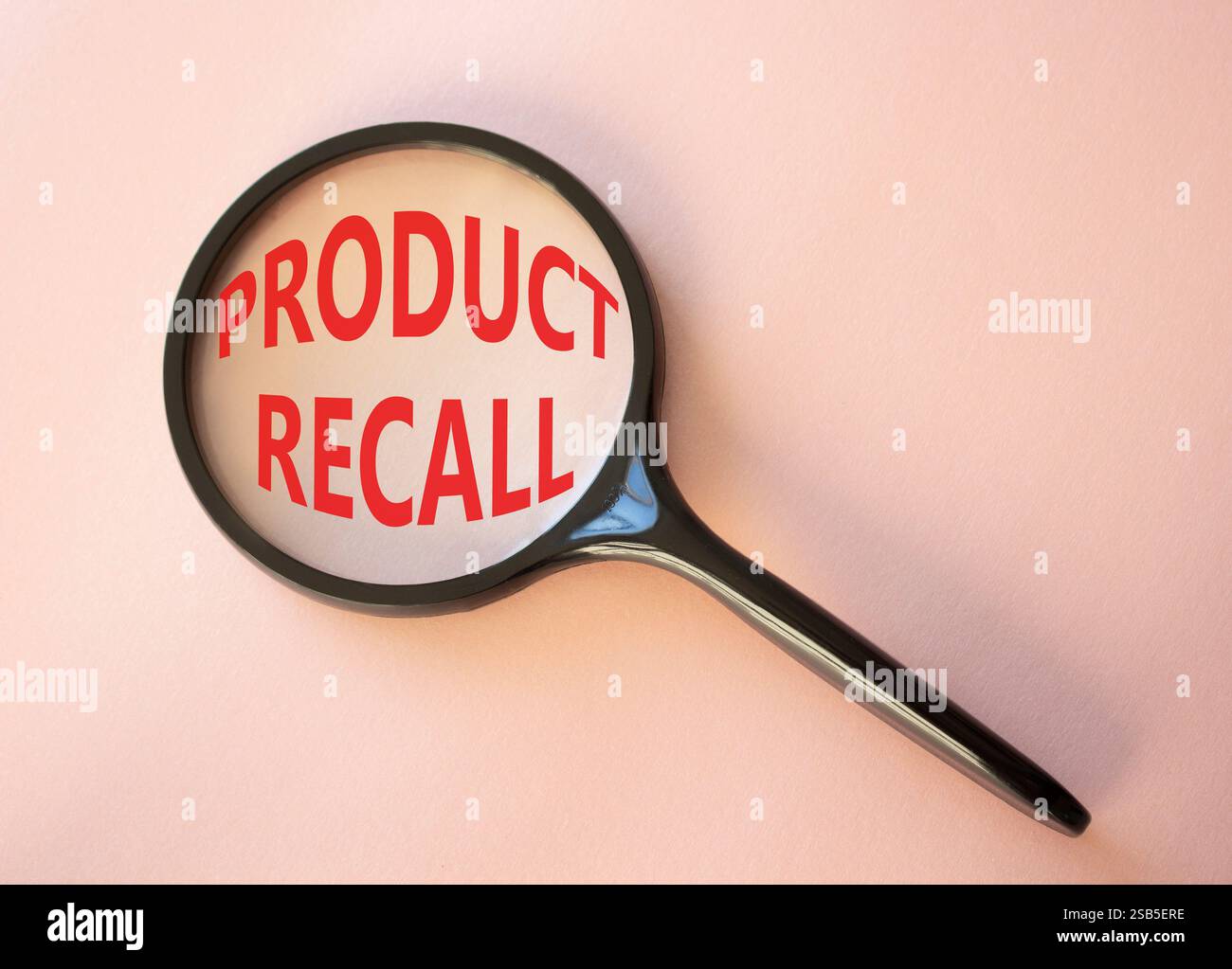 Product recall symbol. Concept words Product recall on magnifying glass. Beautiful pink ...