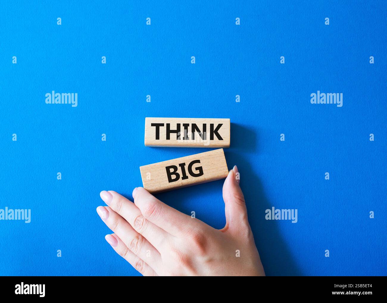 Think big symbol. Wooden blocks with words Think big. Beautiful blue ...