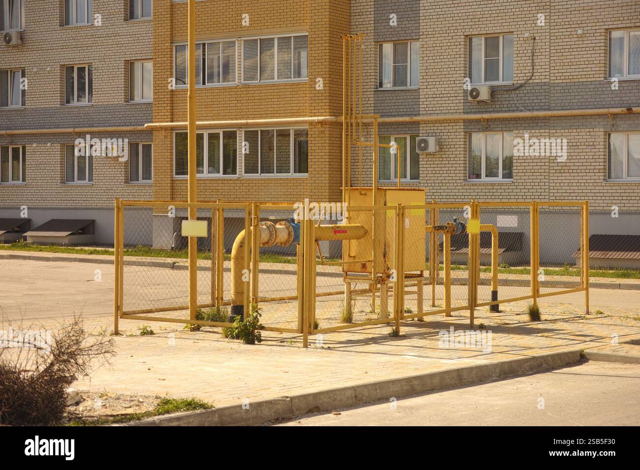Yellow gas pressure regulating and distribution point outdoors next to ...