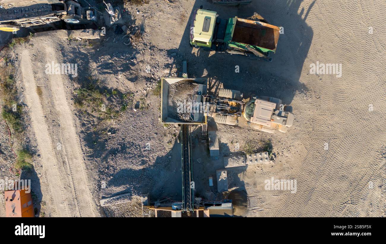 Aerial view of an quarry processing site site with heavy machinery and ...
