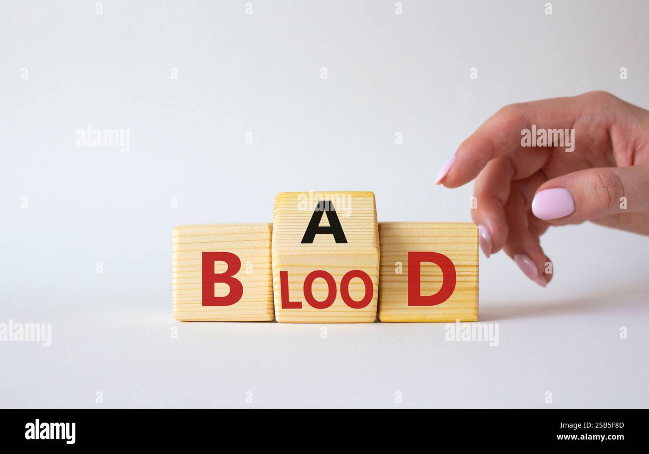 Breed Bad Blood symbol. Businessman hand turns wooden cubes with words ...