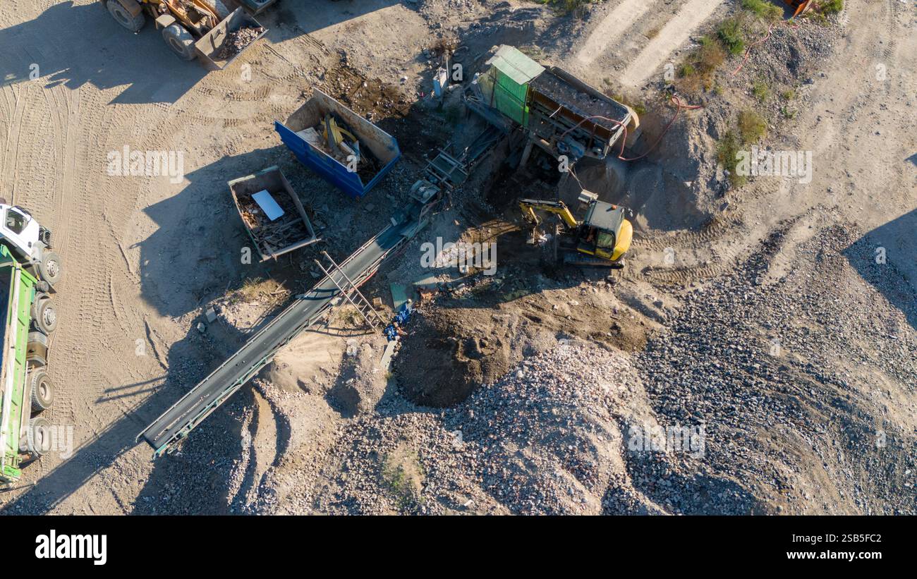 Aerial view of an quarry processing site site with heavy machinery and ...