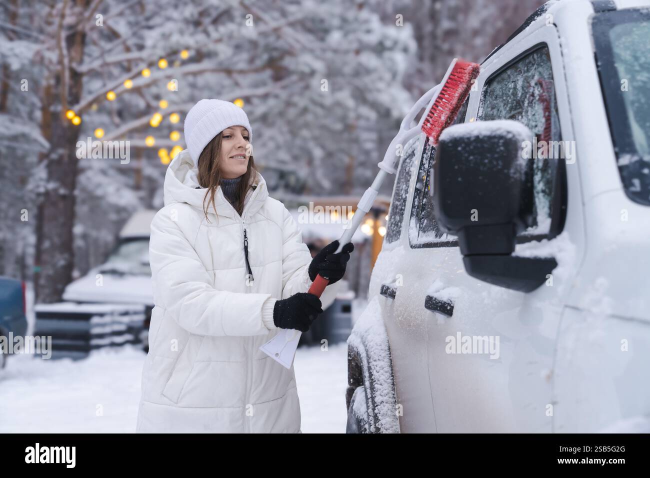 Beautiful woman cleans snow from hi-res stock photography and images ...