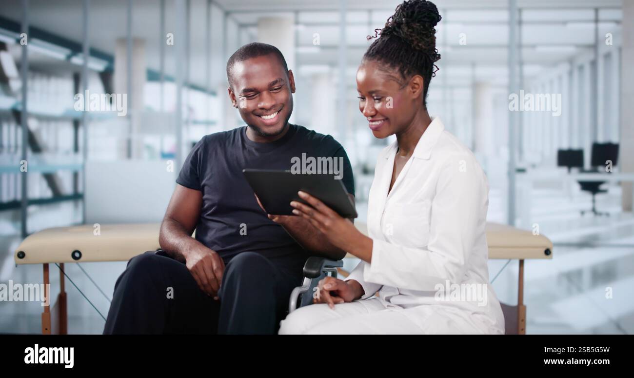 Happy African Doctor With Male Patient In Hospital Using Tablet Stock ...