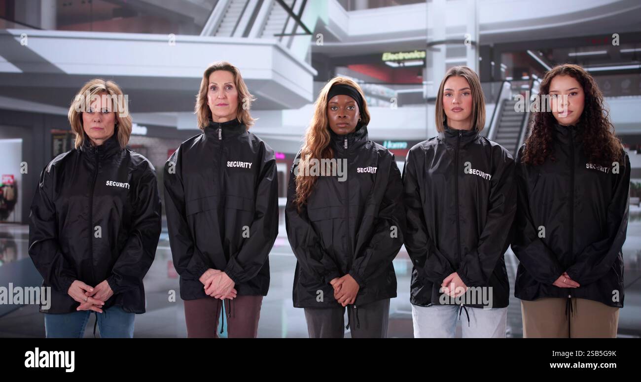 Black female security officers standing in mall, protecting diverse ...