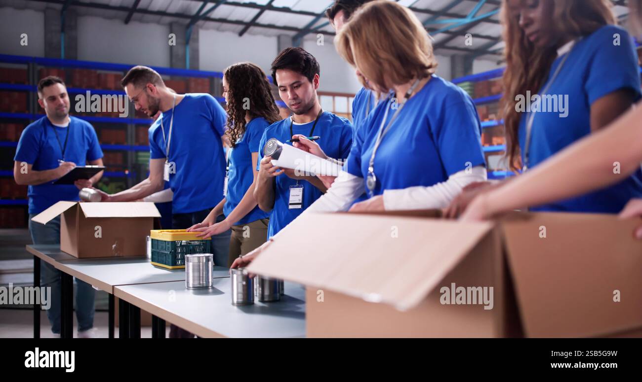 Diverse group packing donations at nonprofit food bank warehouse Stock ...
