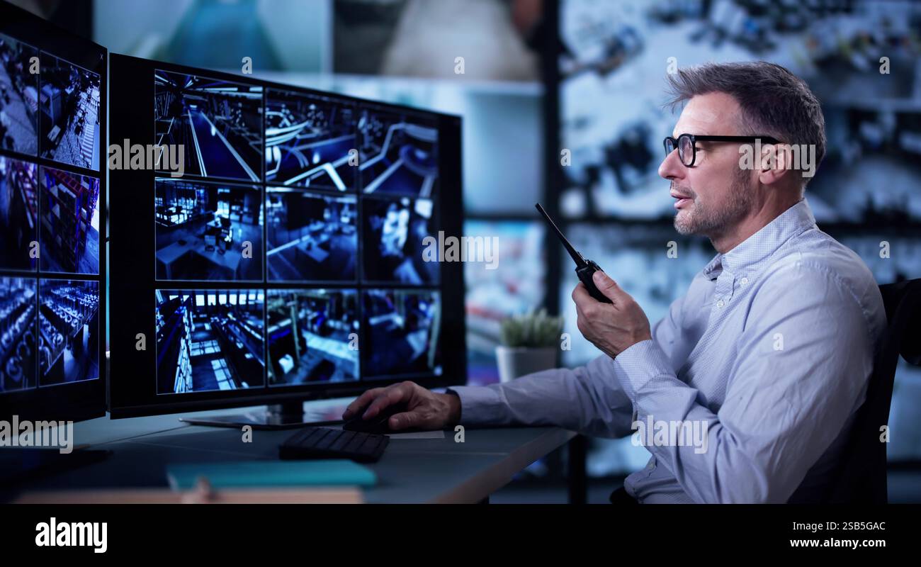 Male Security Guard Talking On Walkie-talkie While Monitoring Multiple ...