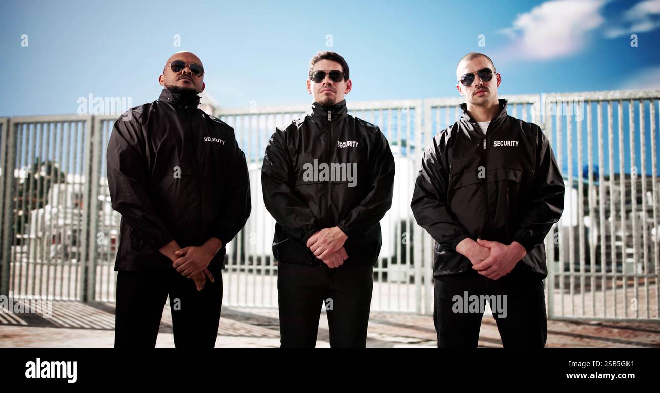 Diverse group of security guard officers protecting warehouse gate ...