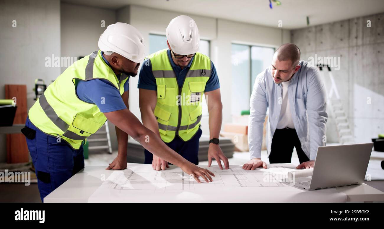 African American builder inspects house interior with diverse group ...