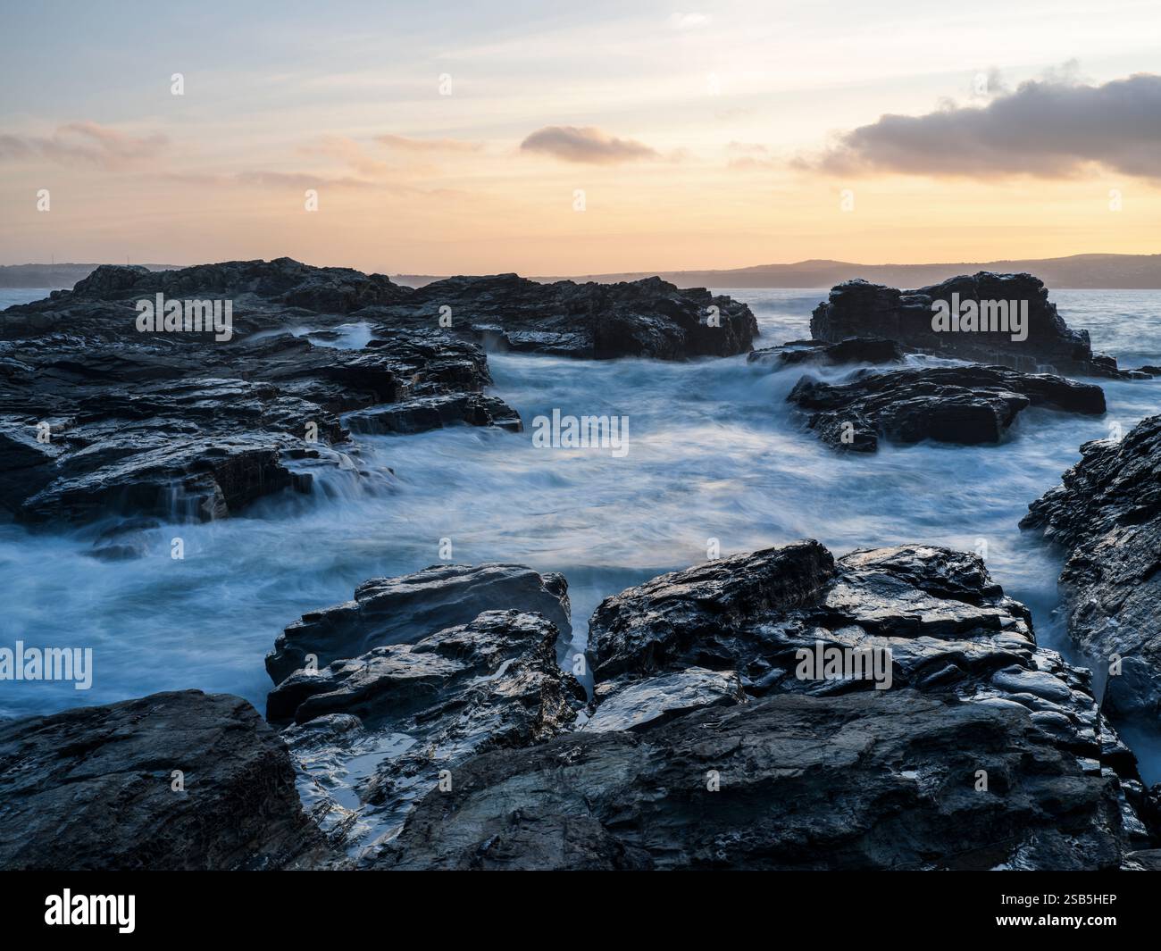 GODREVY ROCKS AND ROUGH SEA WAVES BREAKING OVER ROCKS Stock Photo - Alamy