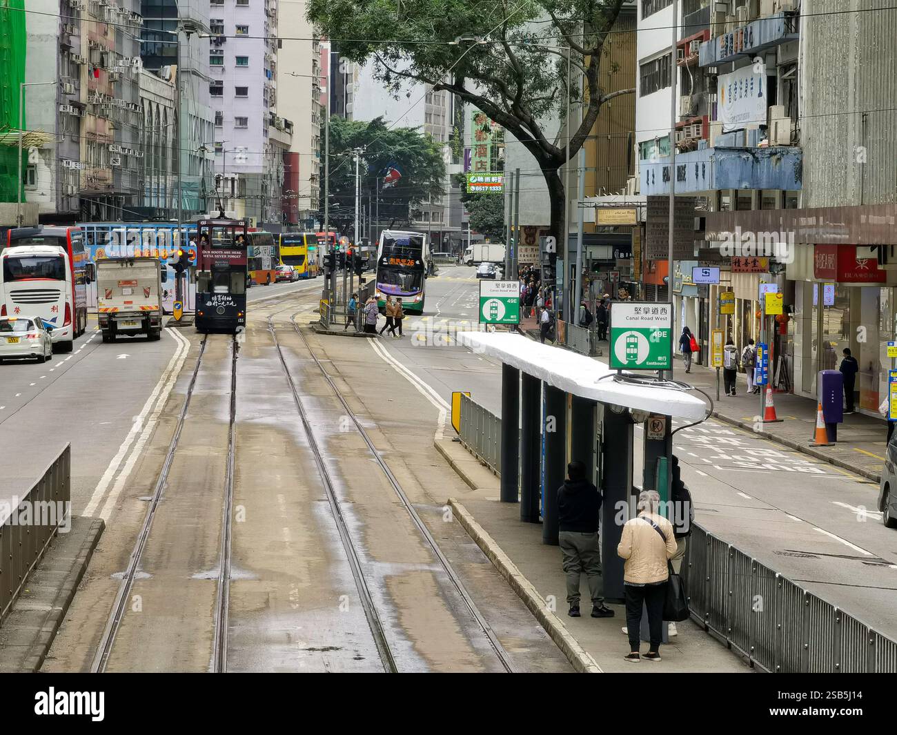 Hong Kong, China - February 01, 2025 : A Hong Kong tram stop on a busy ...