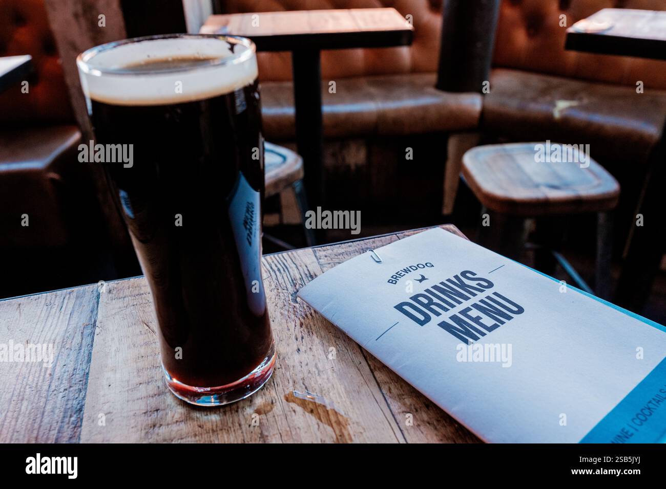 Glasgow Scotland: 8th Jan 2025: Enjoying a frothy dark beer with a ...