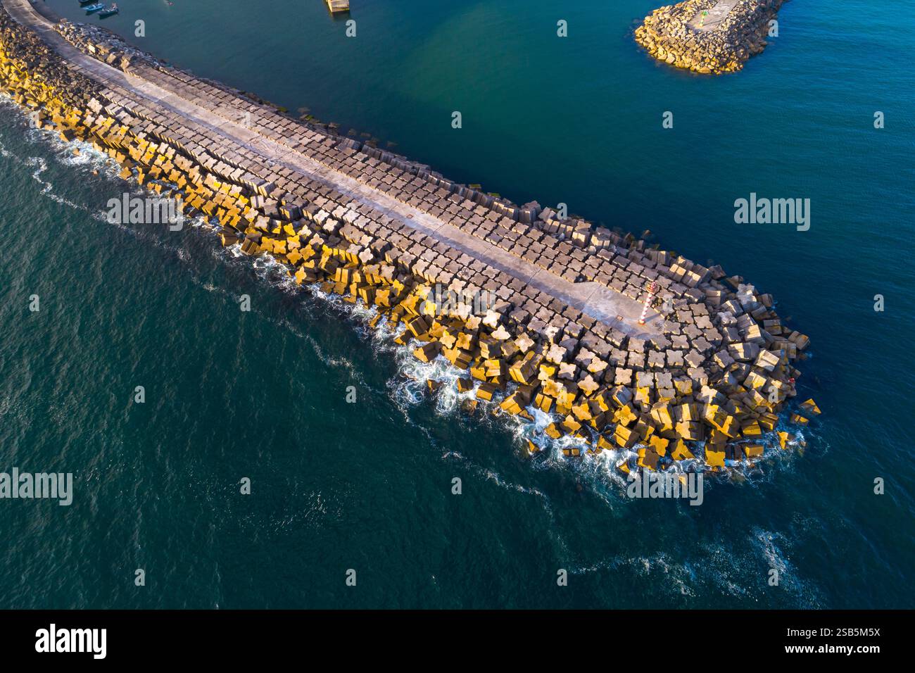 Coastal breakwater for the protection of a harbor, aerial view with a ...