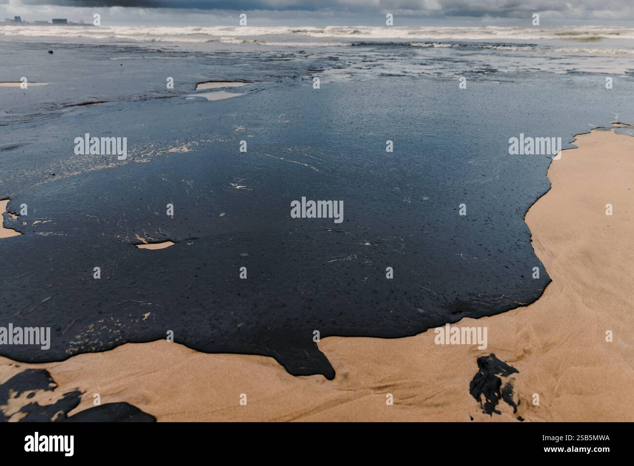 Oil in coastline after a tanker wreck. Fuel oil leak and polluted beach ...
