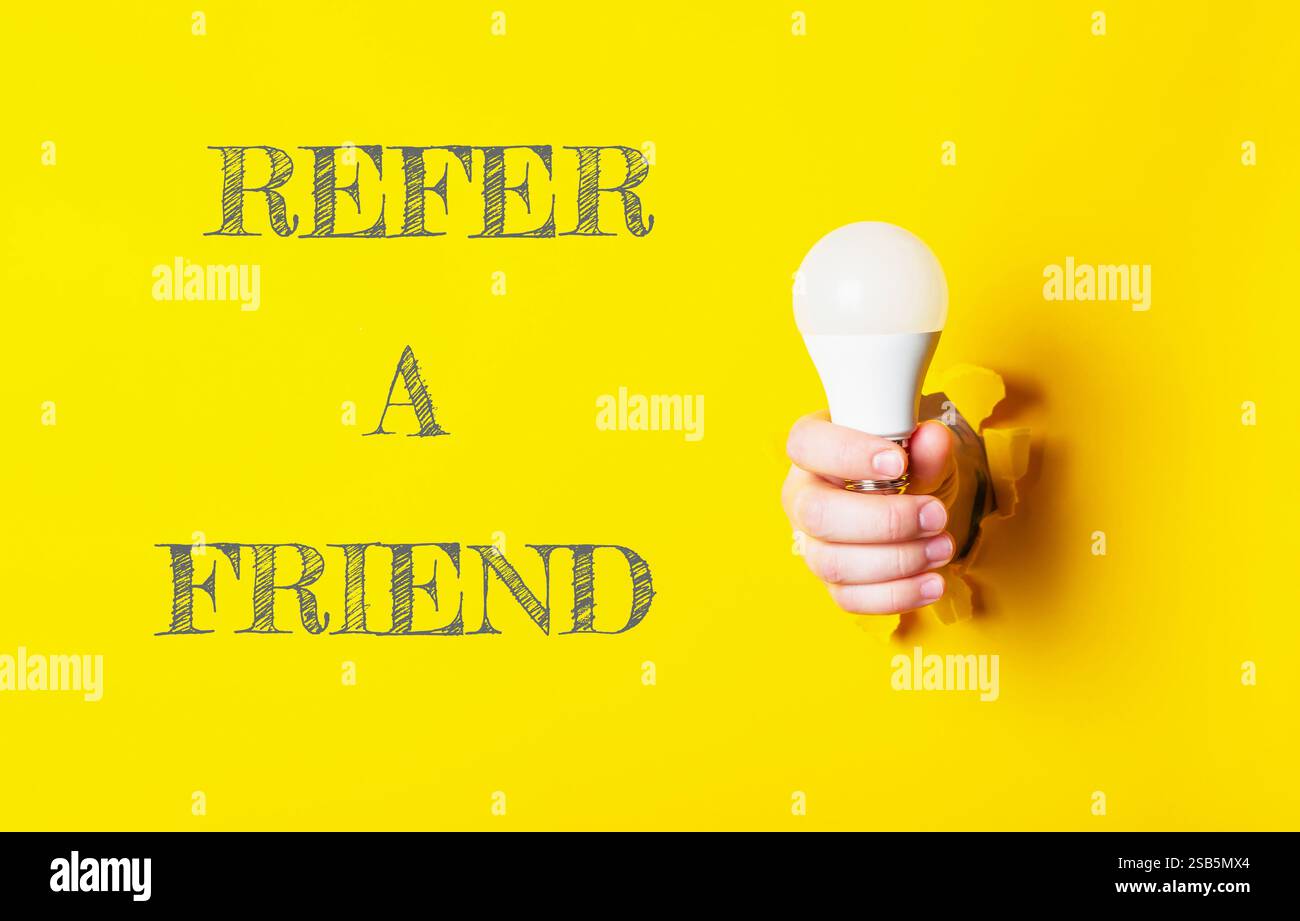 Person holding a light bulb with the words Refer a Friend written below ...