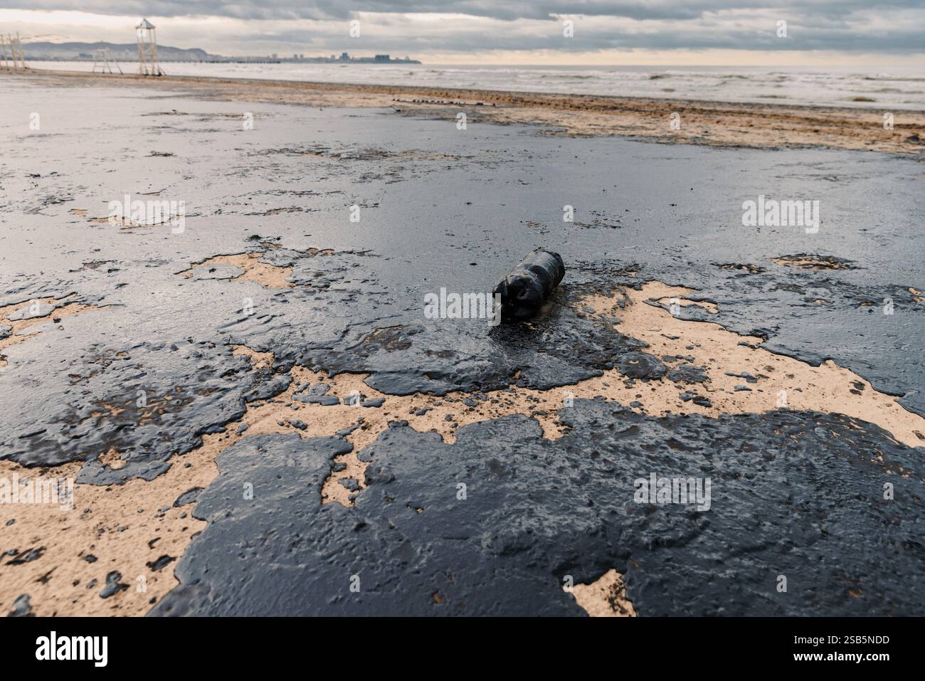 Oil in ocean coastline after a tanker wreck and leakage. The beach is ...