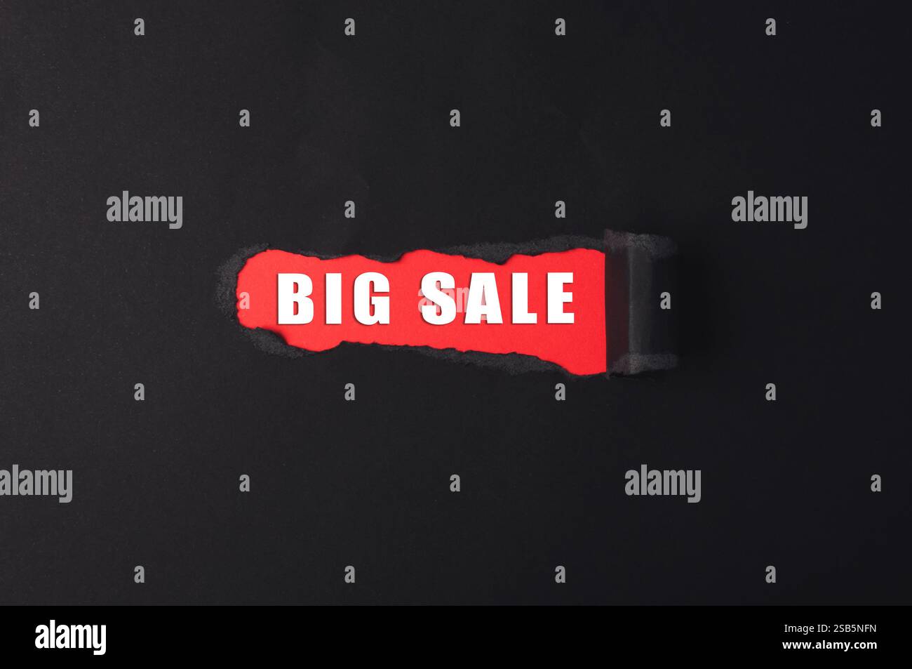 Red sign with the word big sale written on it. The sign is torn in half ...