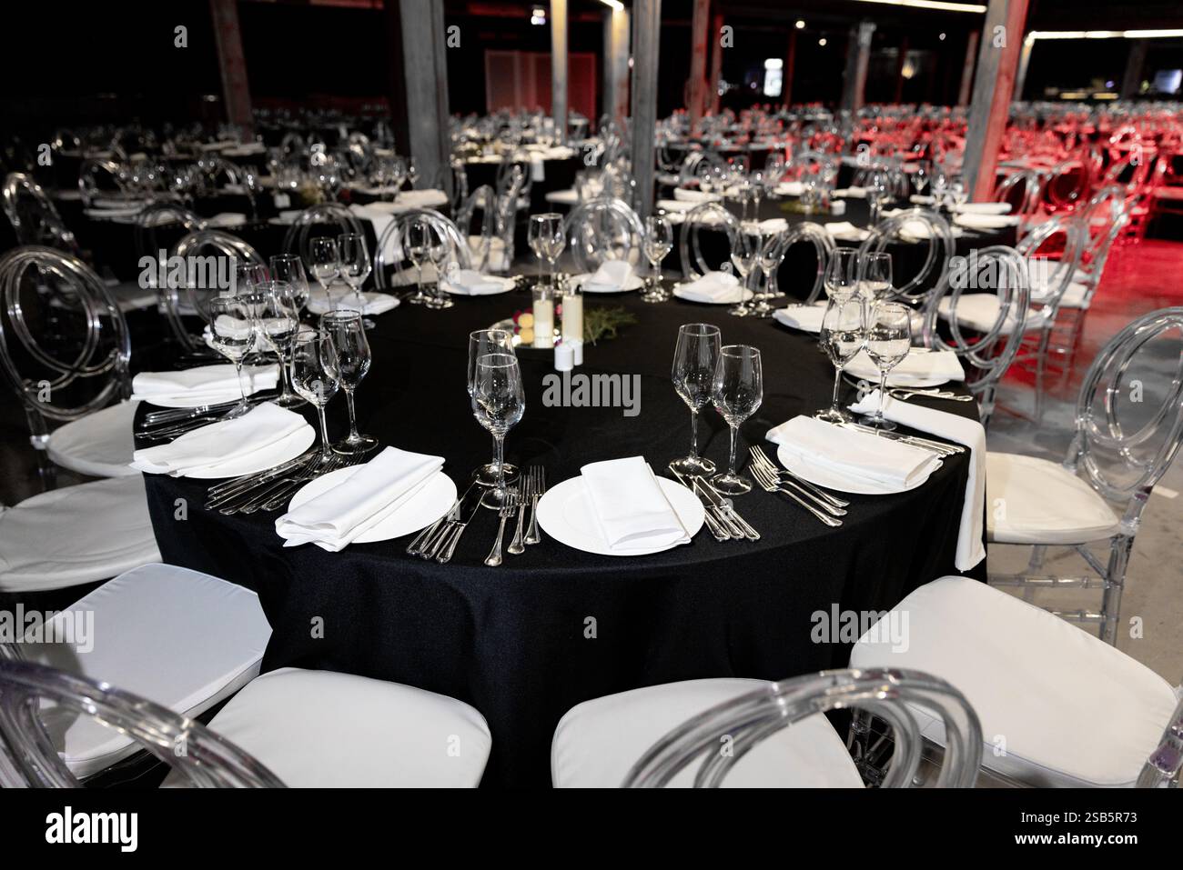 Close-up of an elegant round table setup, plates, glasses, and food ...