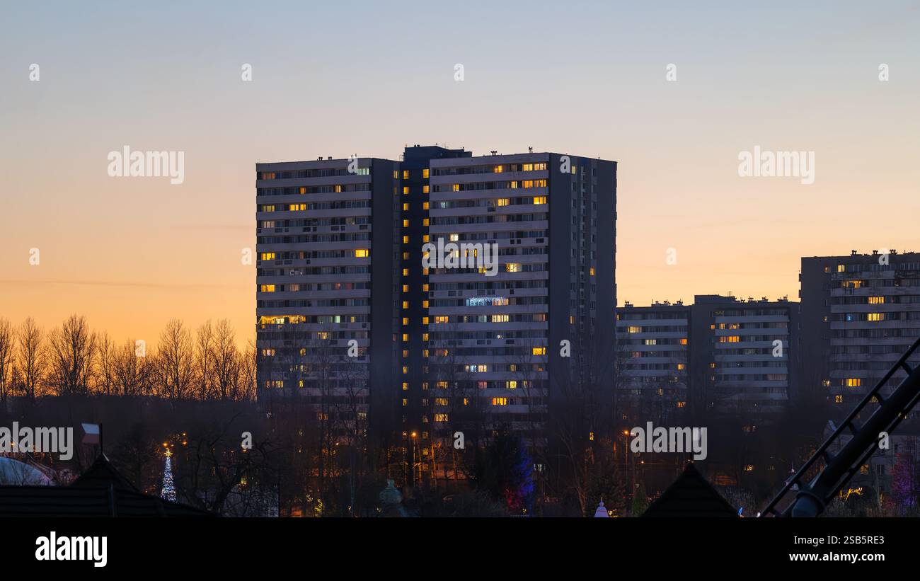 Residential buildings with illuminated apartments against the ...