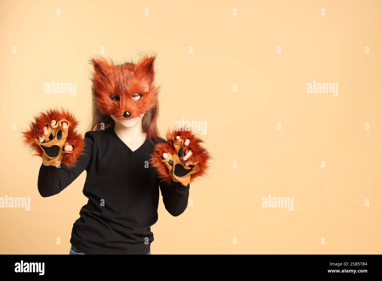 Quadrobics. Girl wearing fox mask and gloves on beige background, space ...