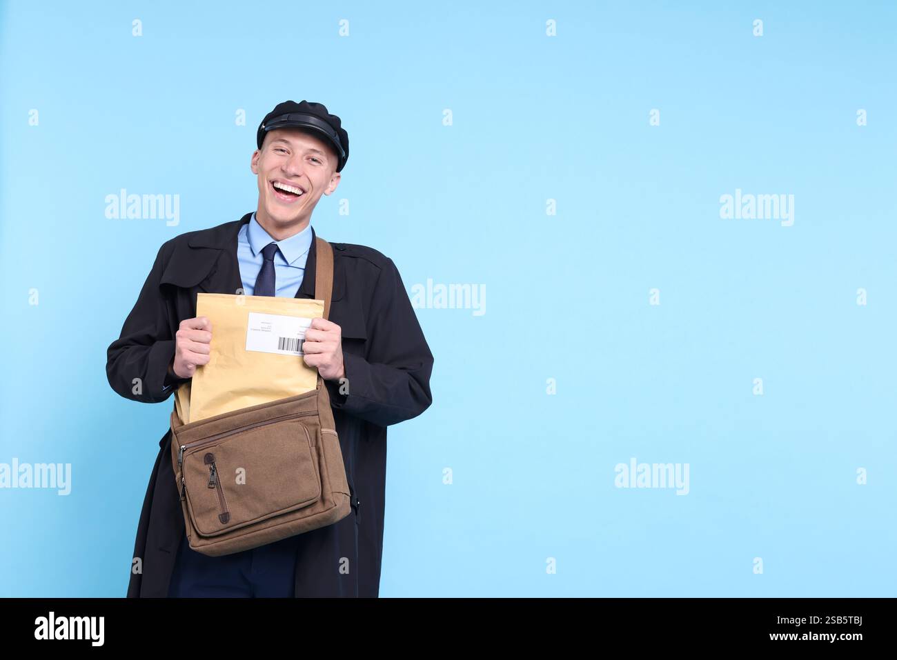 Happy postman with bag and envelopes on light blue background. Space ...