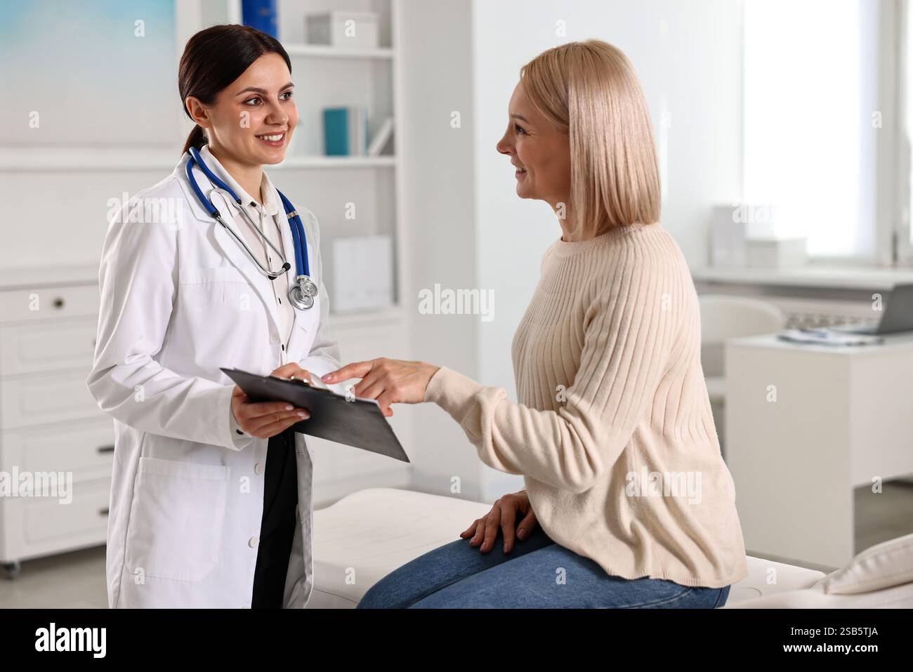 Woman having appointment with doctor in hospital Stock Photo - Alamy