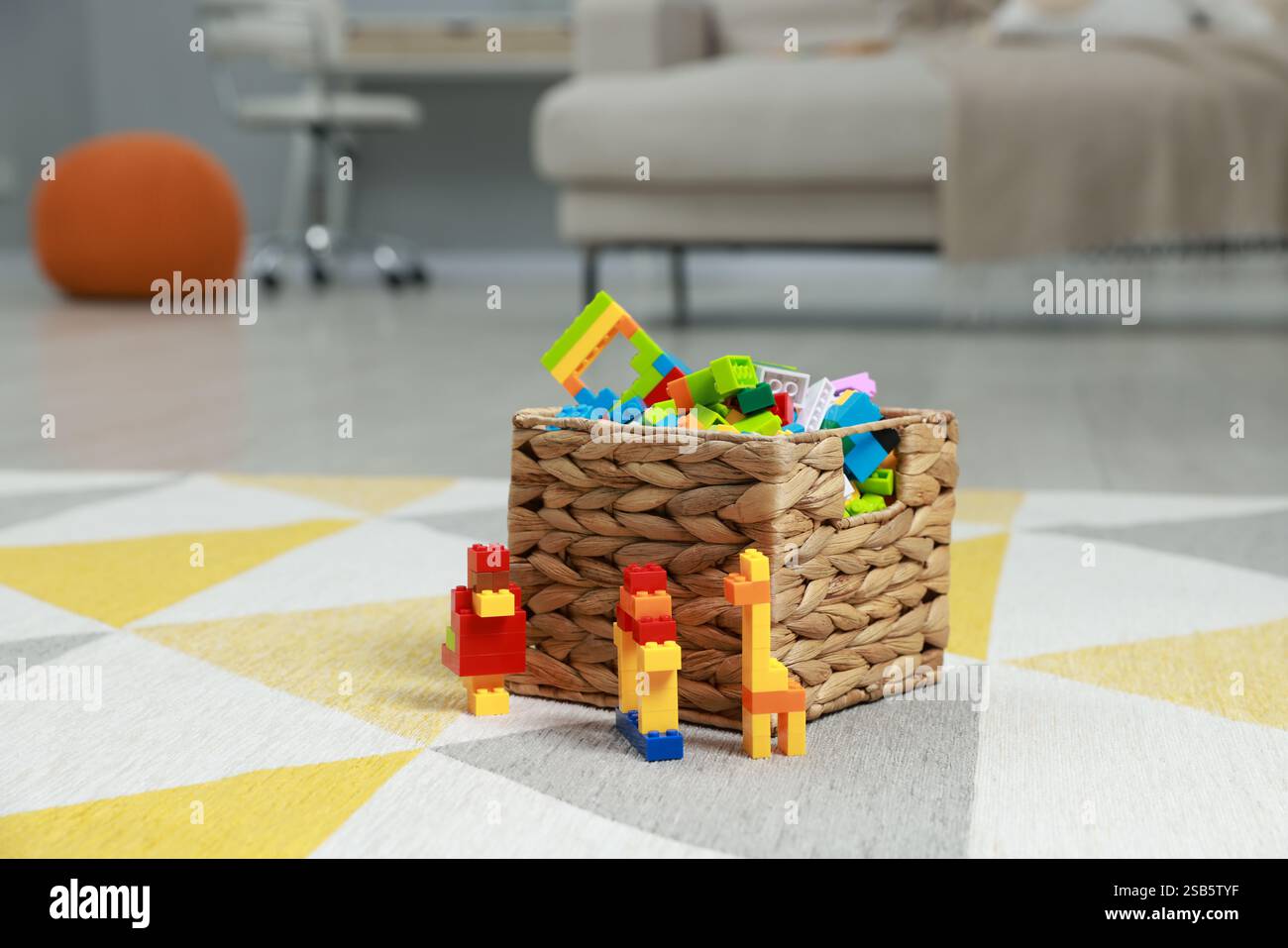 Construction toy. Figures made with building bricks and wicker basket ...