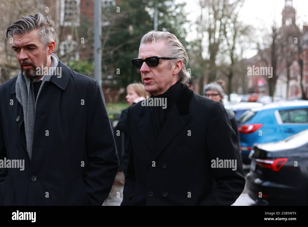 Author Glenn Patterson (right) arrives for the funeral of acclaimed ...