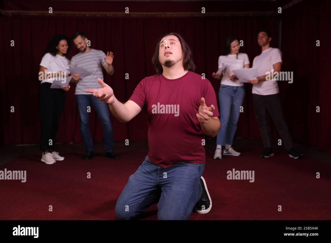 Professional actors with their scripts rehearsing in theatre Stock ...