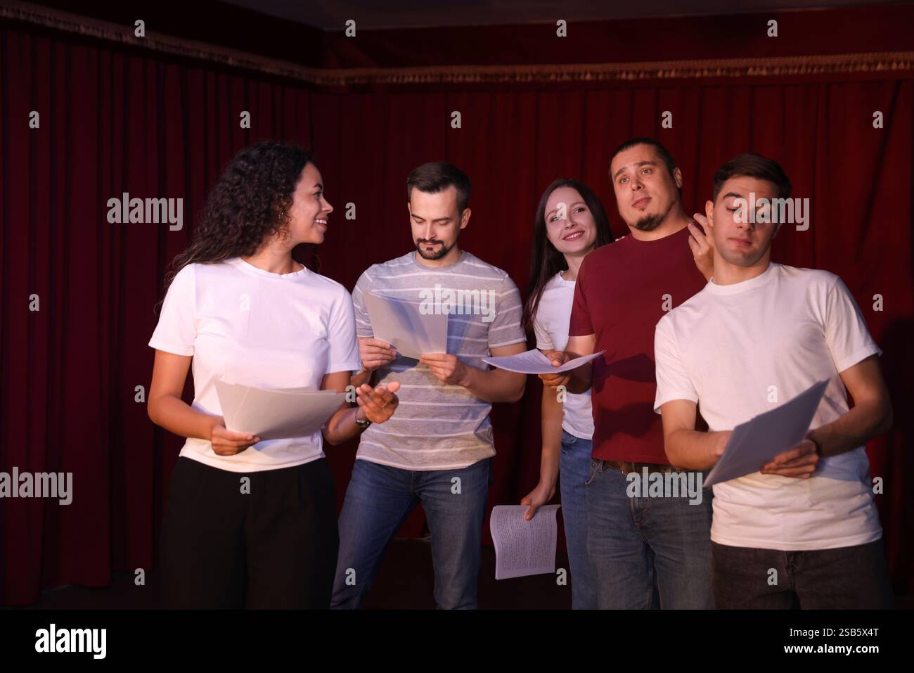 Professional actors with their scripts rehearsing in theatre Stock ...