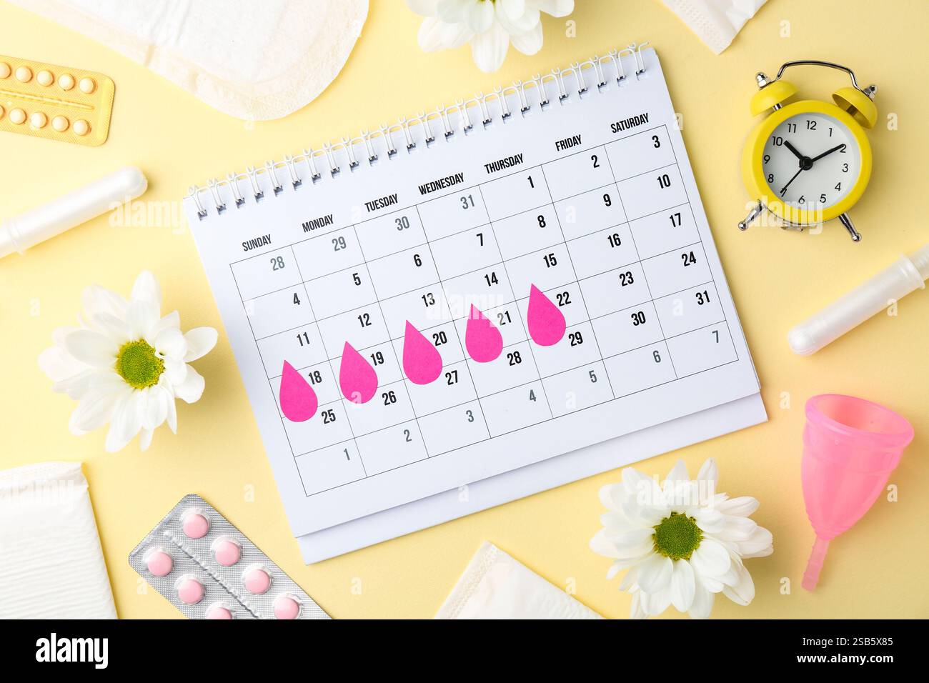 Flat lay composition with calendar and menstrual products on beige ...