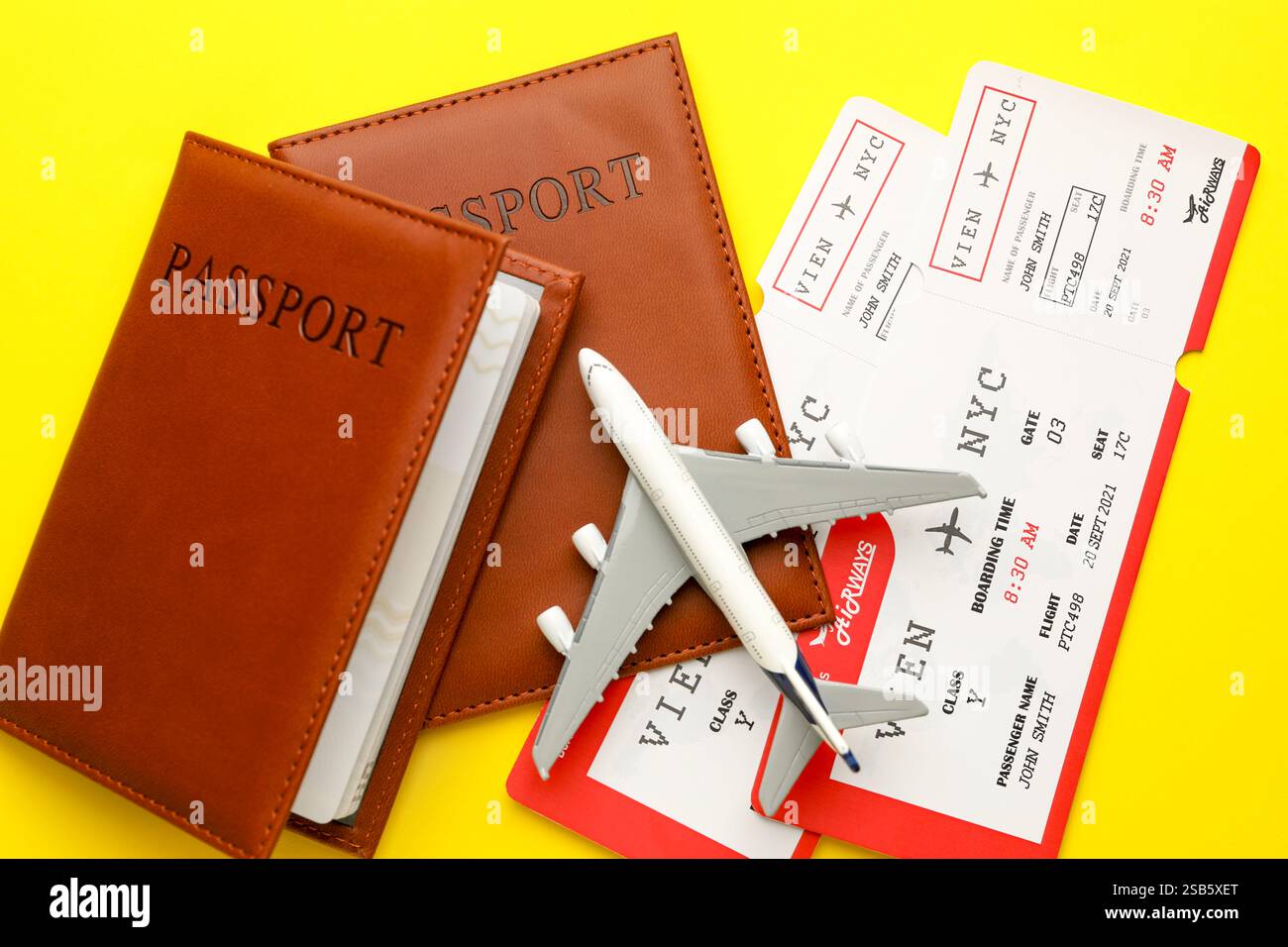 Travel agency. Flight tickets, passports and plane model on yellow ...