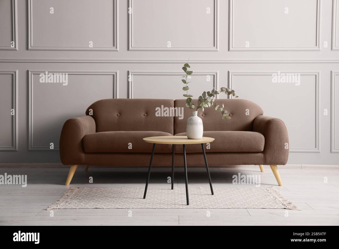 Sofa in mocha mousse shade and table indoors. Interior with trendy ...