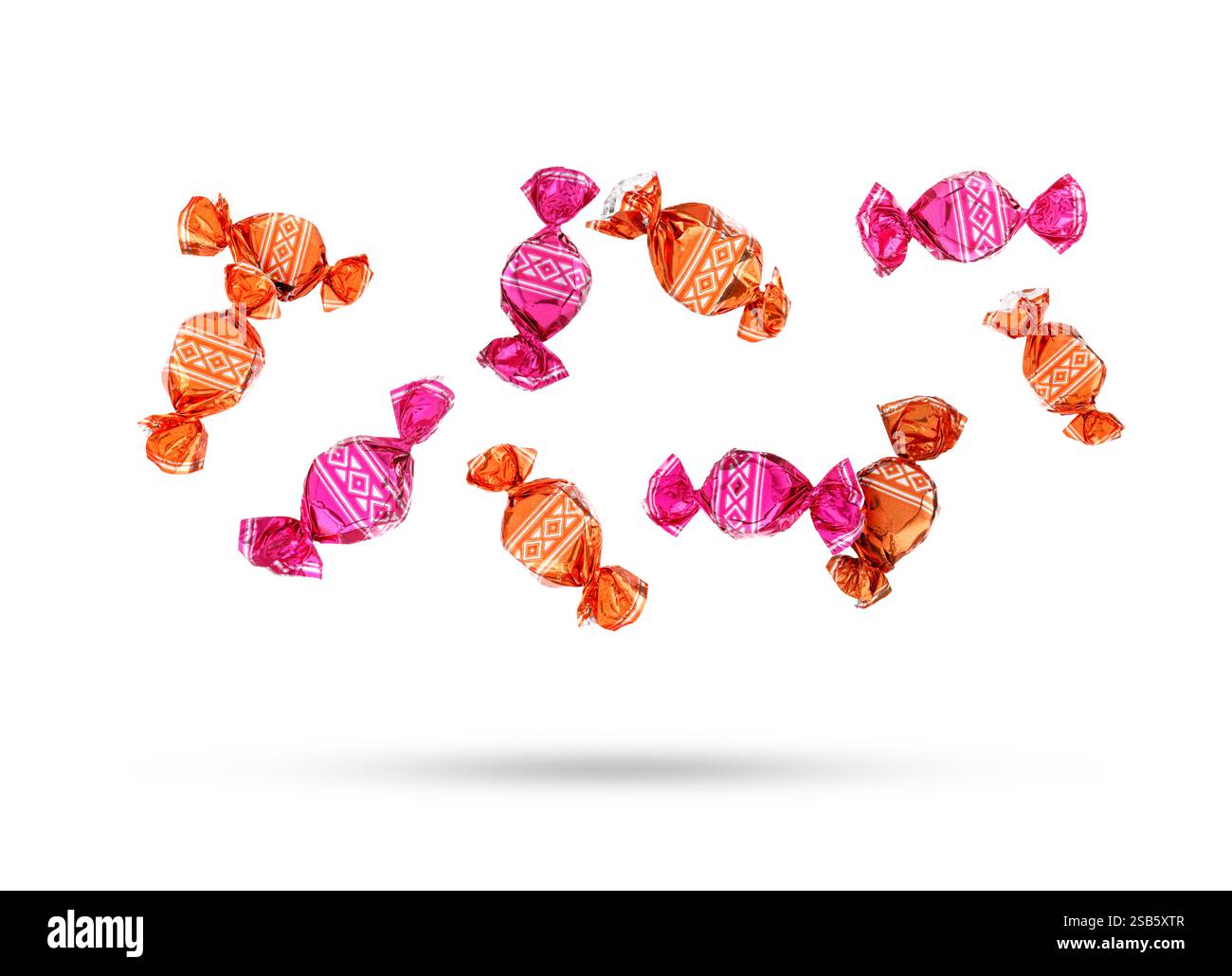 Candies in bright wrappers falling on white background Stock Photo - Alamy