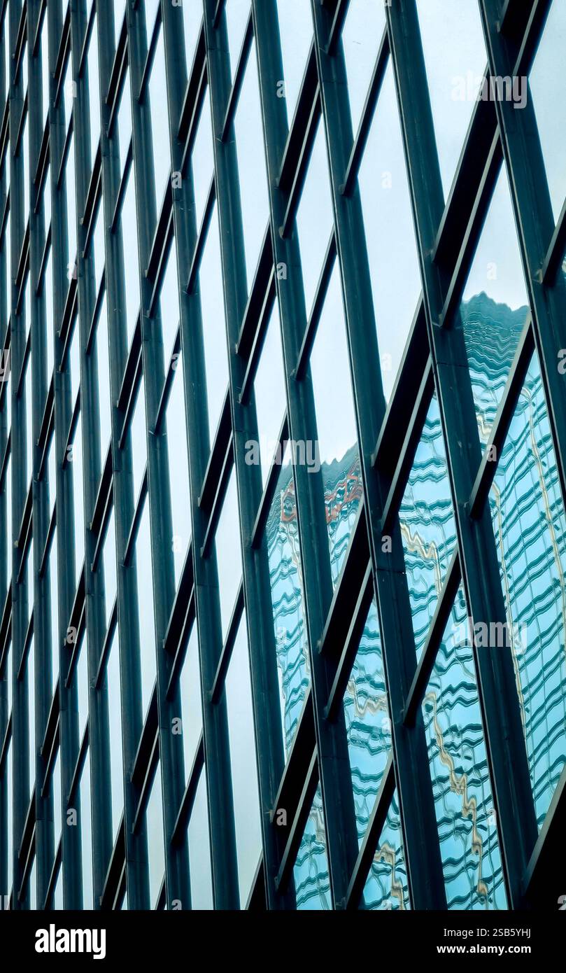 Close-up view of a modern Hong Kong building's glass facade, reflecting ...