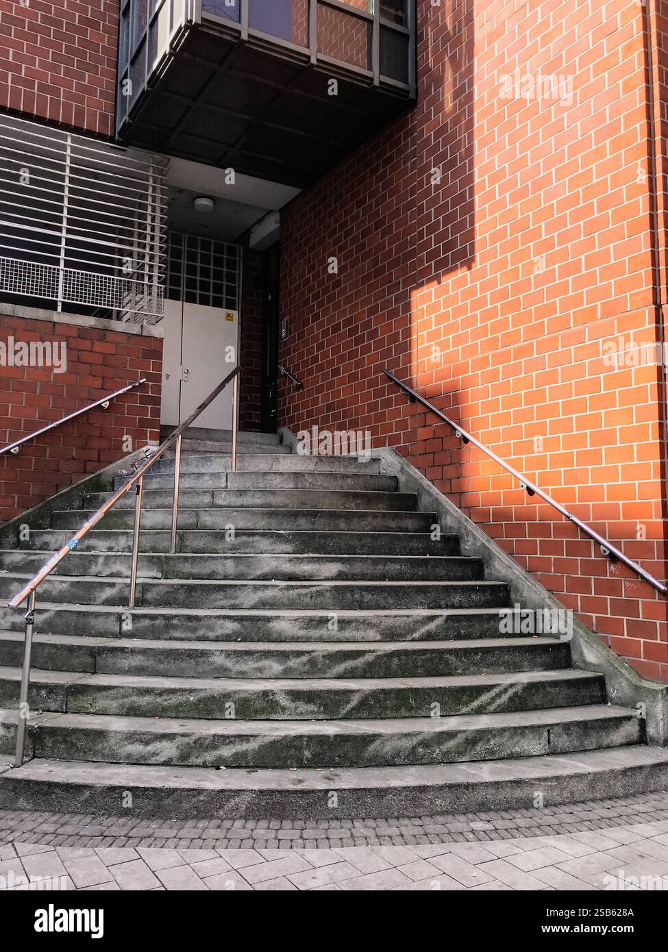 Brick building with a staircase leading up to the entrance. The steps ...