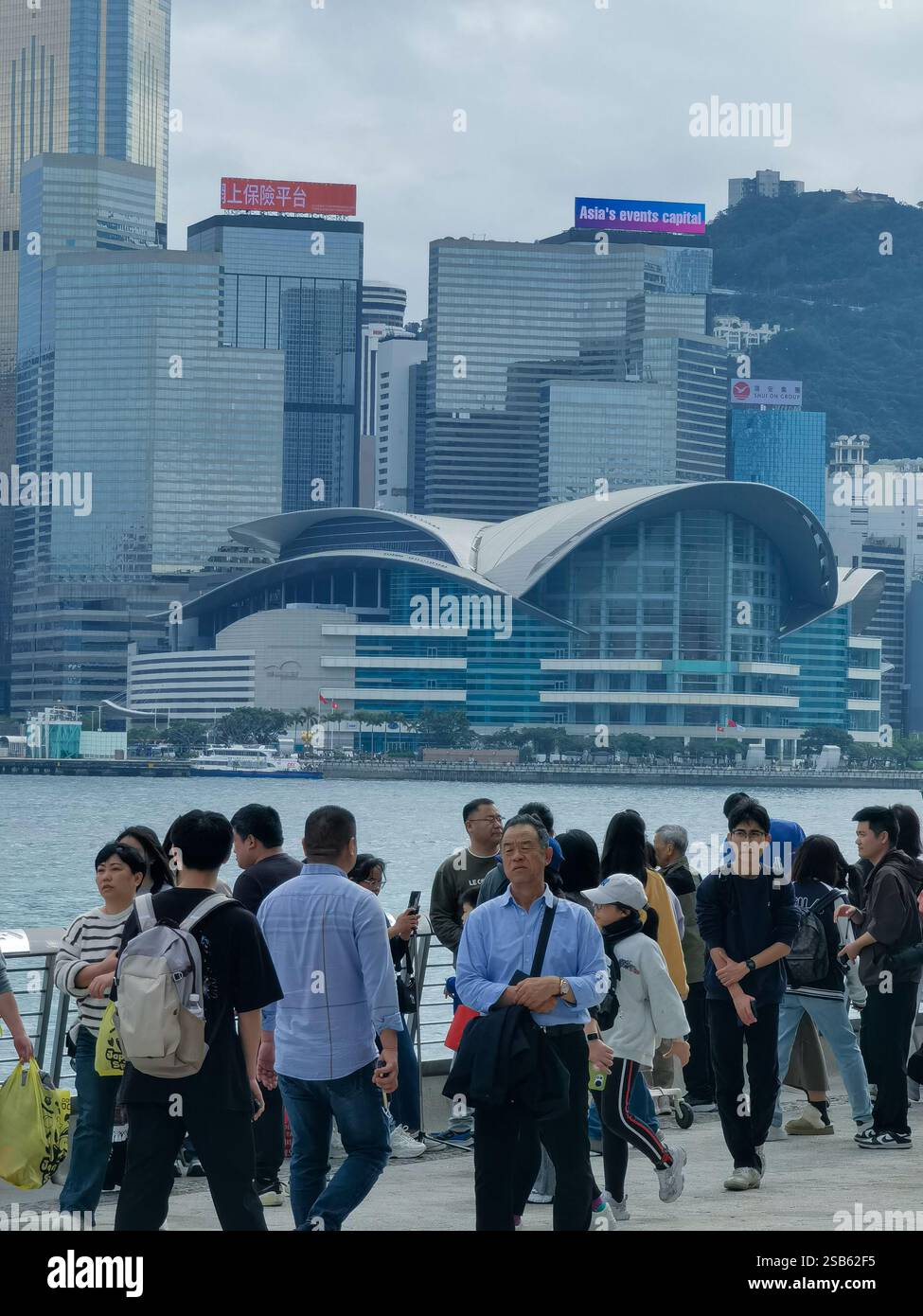 Hong Kong, China - February 01, 2025 : Tourists enjoy the Tsim Sha Tsui Promenade during Chinese ...