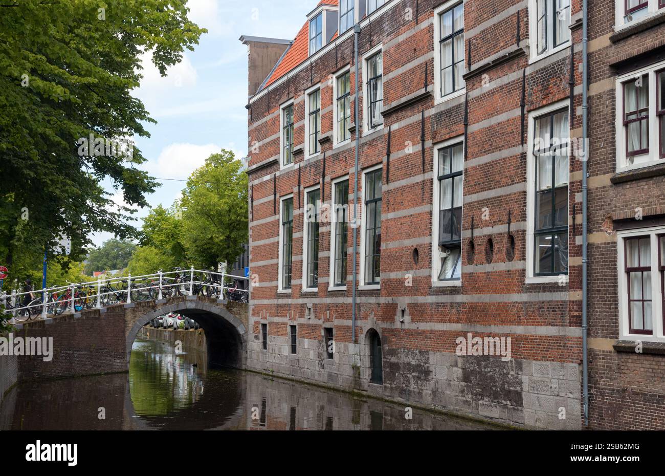 DELFT, THE NETHERLANDS - JULY 26, 2024: Old houses at the Oude Delft ...