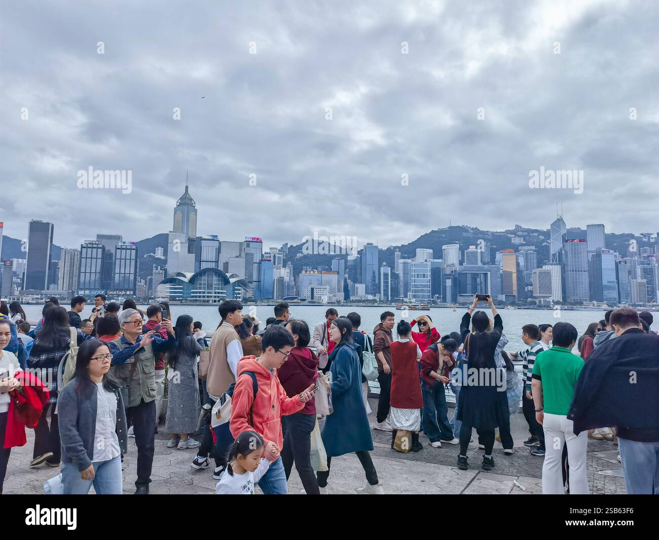Hong Kong, China - February 01, 2025 : A bustling crowd enjoys the Tsim ... Hong Kong, China - February 01, 2025 : A bustling crowd enjoys the Tsim ...