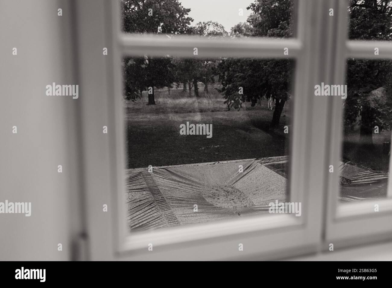 View through a rainy window on a gloomy day, with a blurred outdoor ...