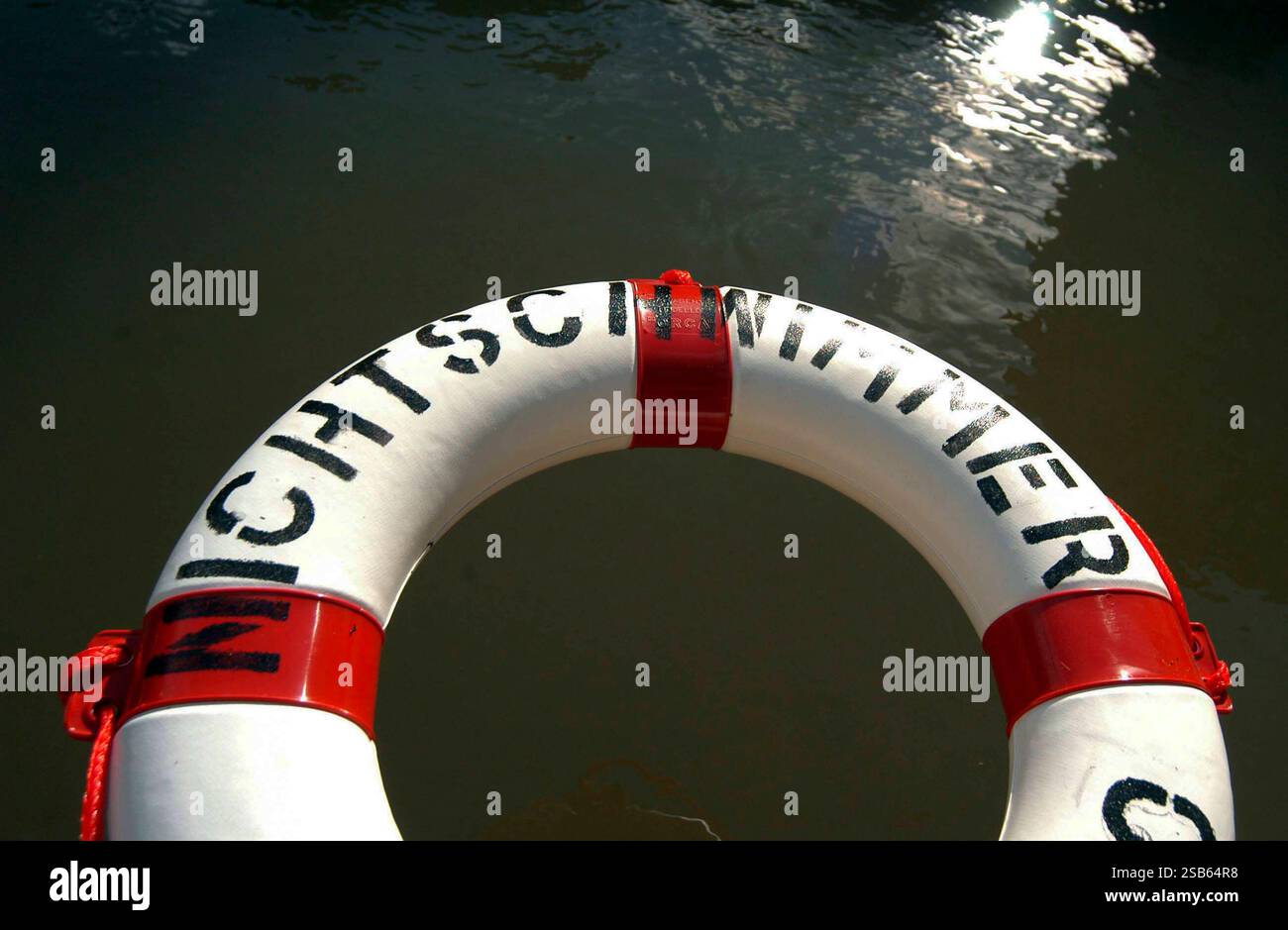life belt with warning sign on risks and hazards in seafaring and ...